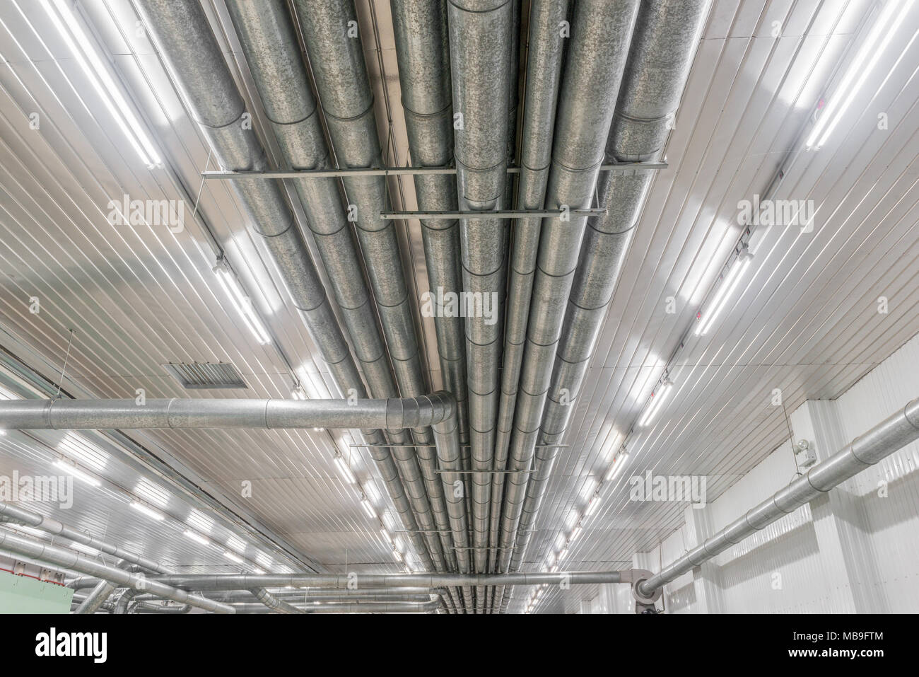 Industrial metal pipes along the ceiling, ventilation system Stock ...
