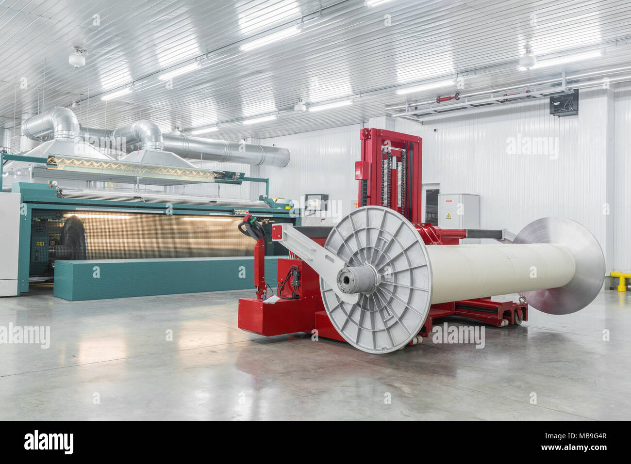 lifting hydraulic machine lifts large coils. textile and spinning mill ...