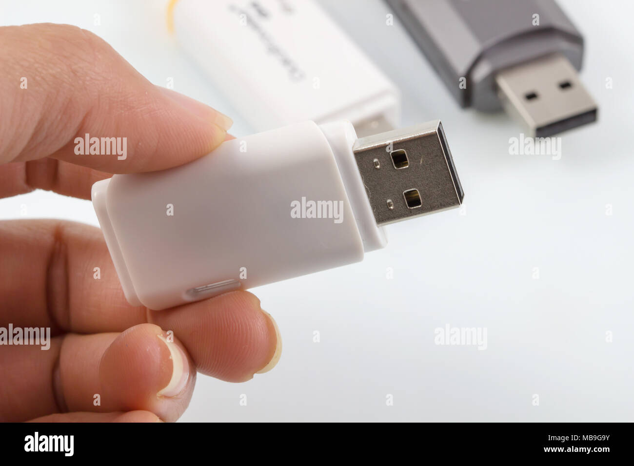 hand holding usb flash, usb memory stick on white Stock Photo - Alamy