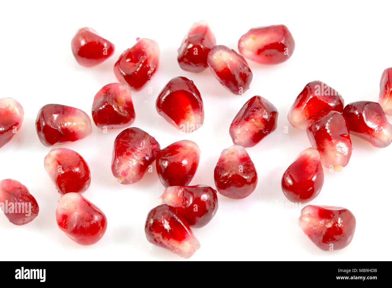 Pomegranate seeds close up isolated on a white background with a ...