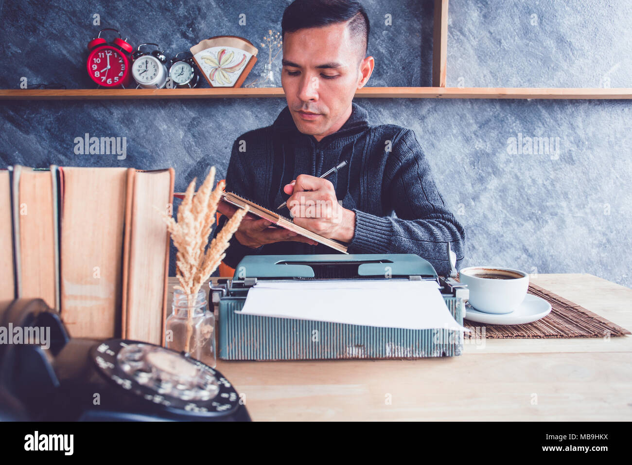 A man officer writing down notes while sitting at office desk Stock ...
