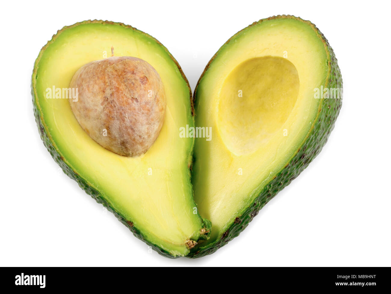 Two slices of fresh avocado with heart symbol isolated on the white ...