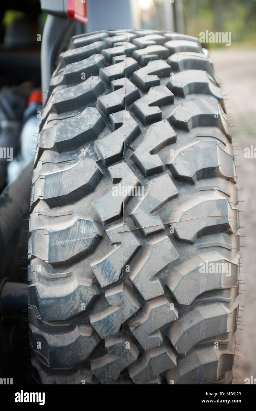 Heavy duty rubber tire with deep treads on an all-terrain 4x4 off road ...