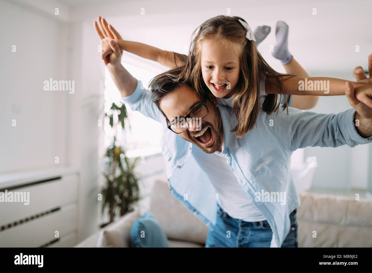 Happy family having fun time at home Stock Photo - Alamy