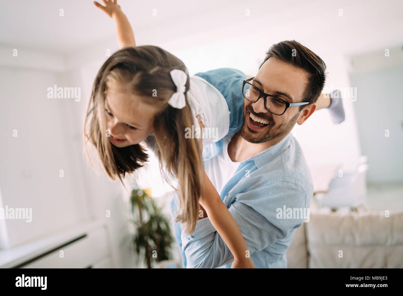 Happy family having fun time at home Stock Photo - Alamy