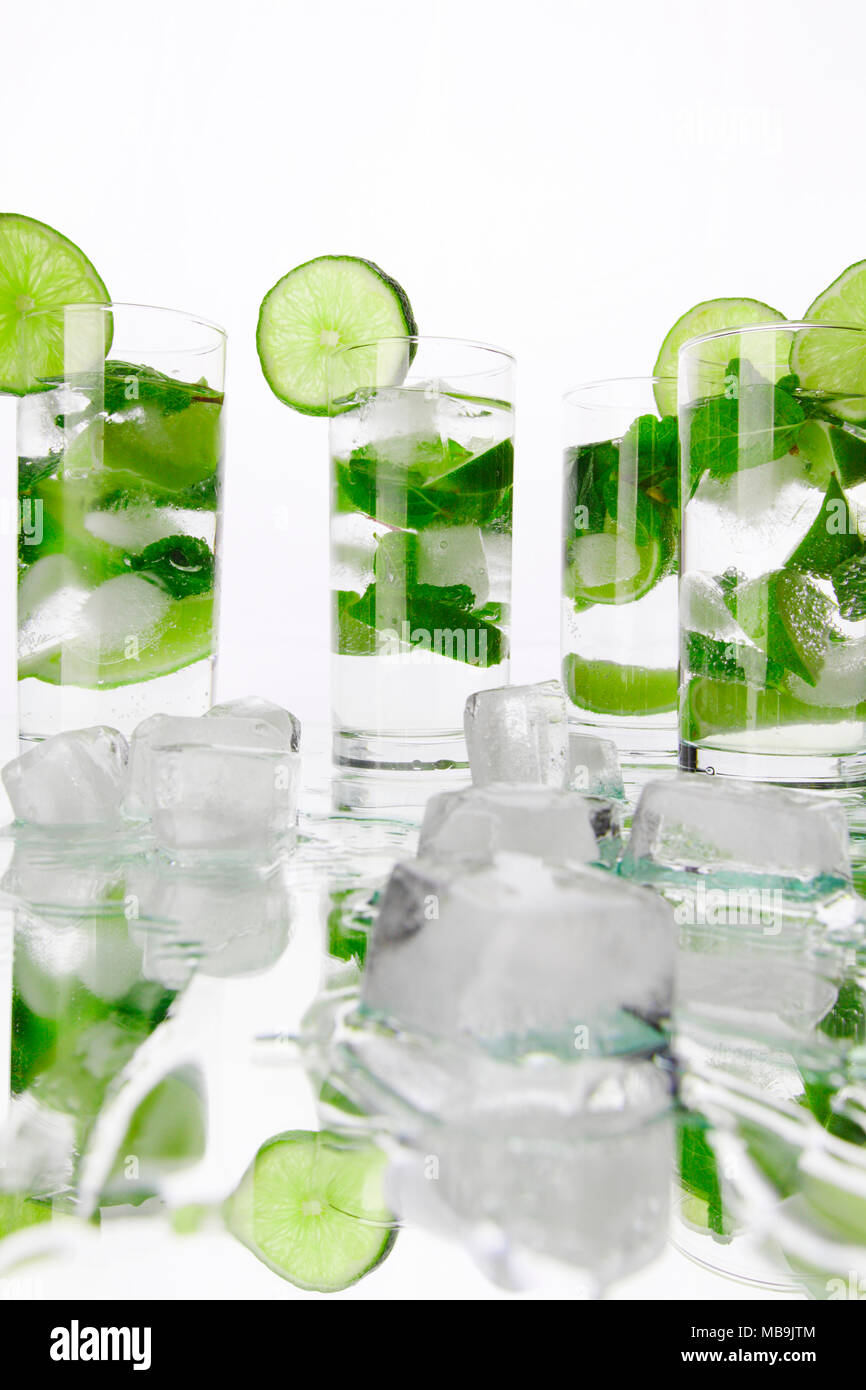 Party mojito cocktails with lime and mint isolated on white background ...
