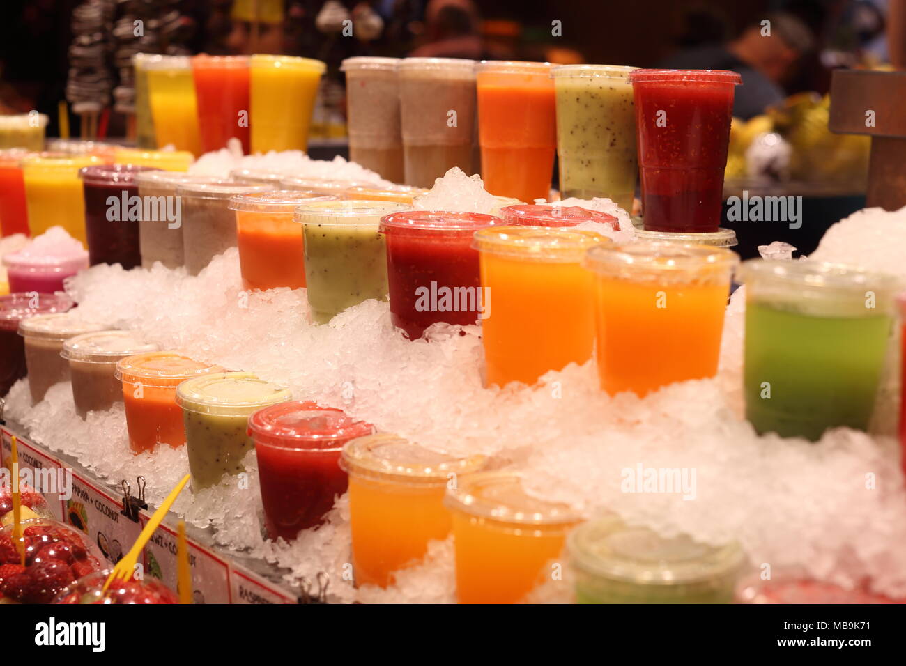 Fresh and healthy fruit juice in closed plastic cups on cold ice Stock ...