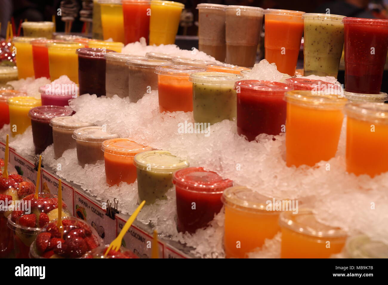 Fresh and healthy fruit juice in closed plastic cups on cold ice Stock ...