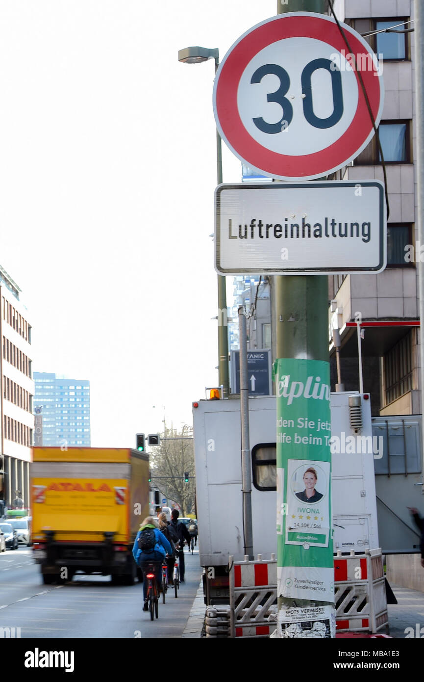 09 April 2018, Germany, Berlin: Cars and trucks drive past a sign ...