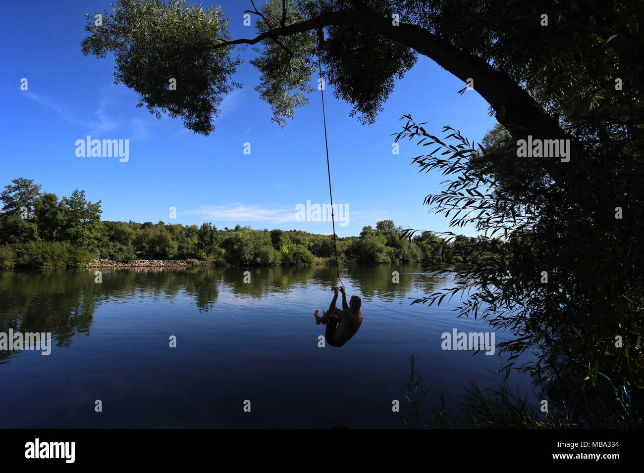 Man swinging from rope hi-res stock photography and images - Alamy