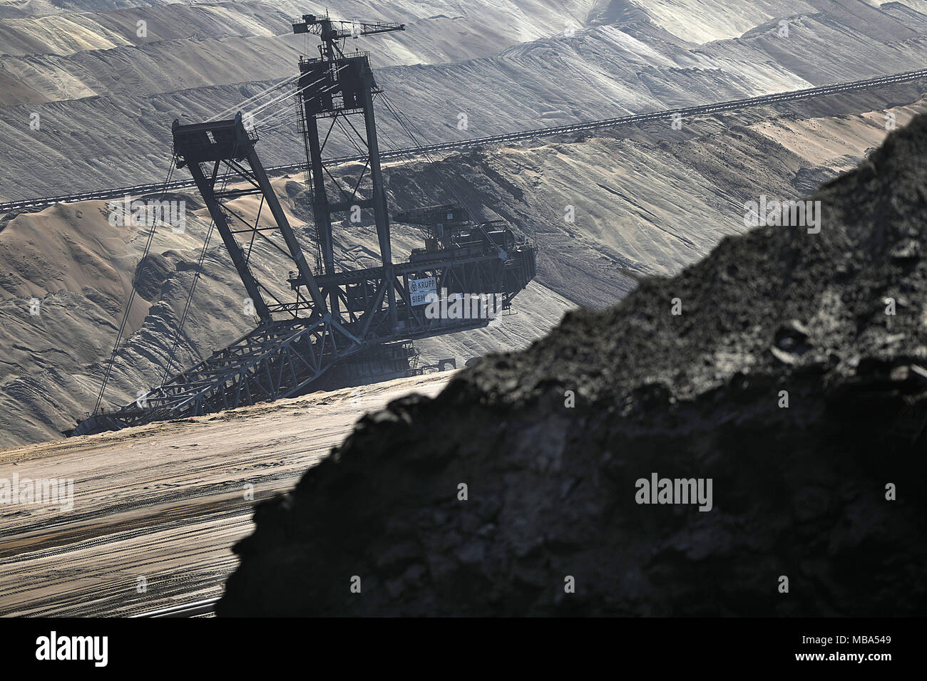 06 April 2018, Germany, Grevenbroich: A bucket wheel excavator mines ...