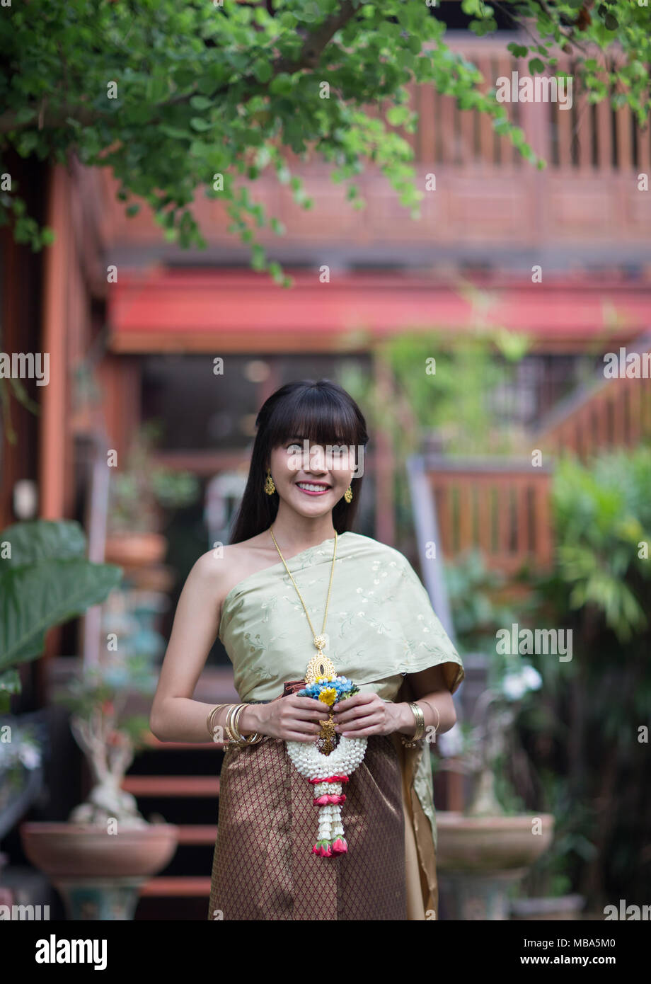 Nice and beautiful smiling Thai girl with Thai ancient style dressing ...