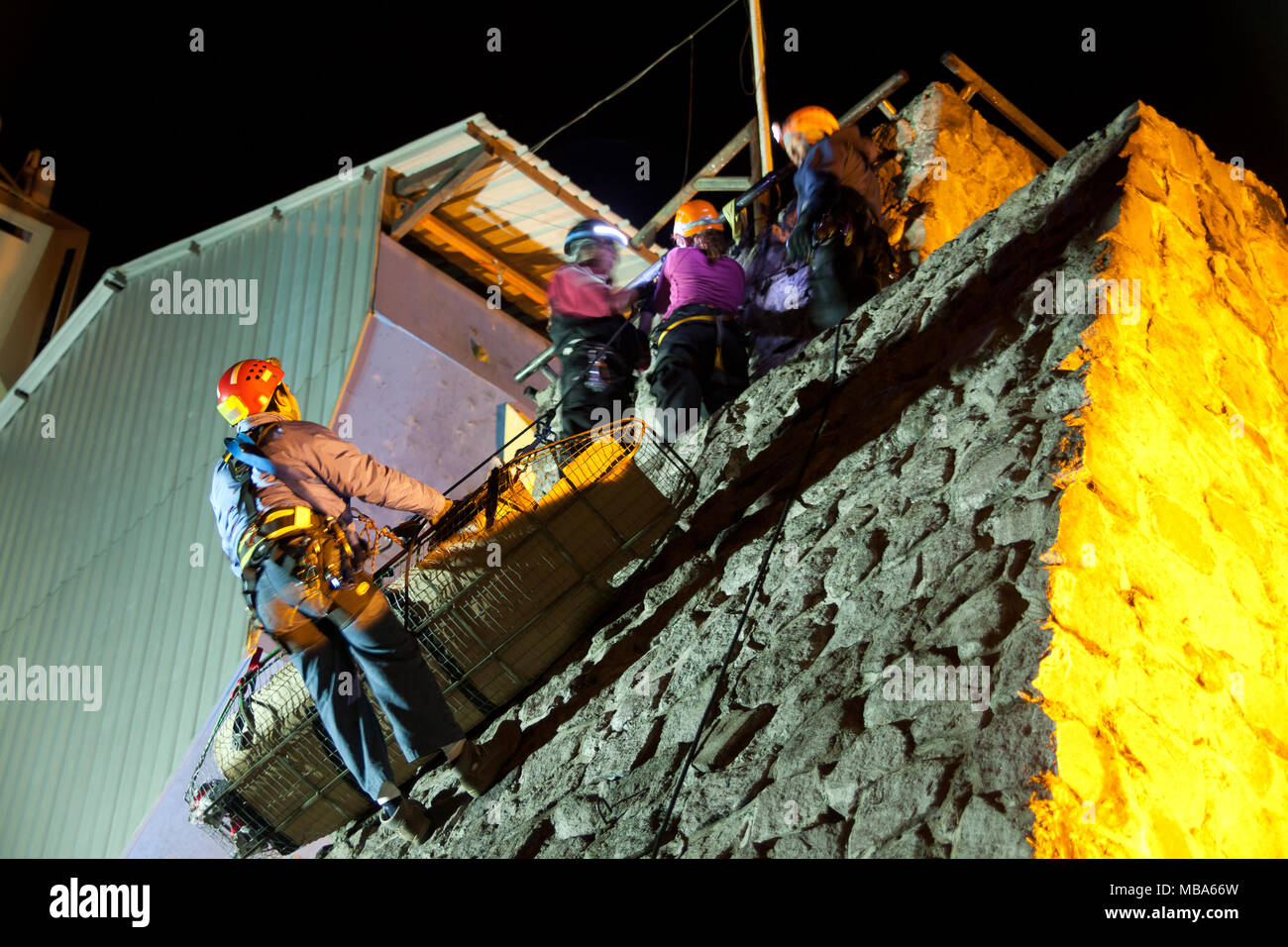 Group of rescuers doing night rescue exercises Stock Photo - Alamy