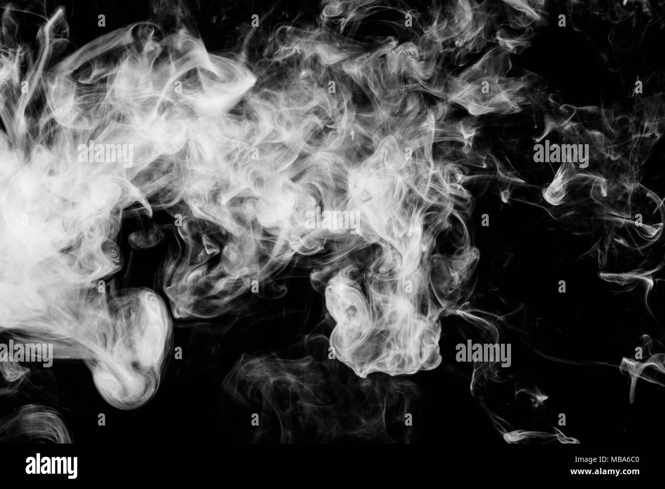 Thick white smoke on a black isolated background. Background from the ...