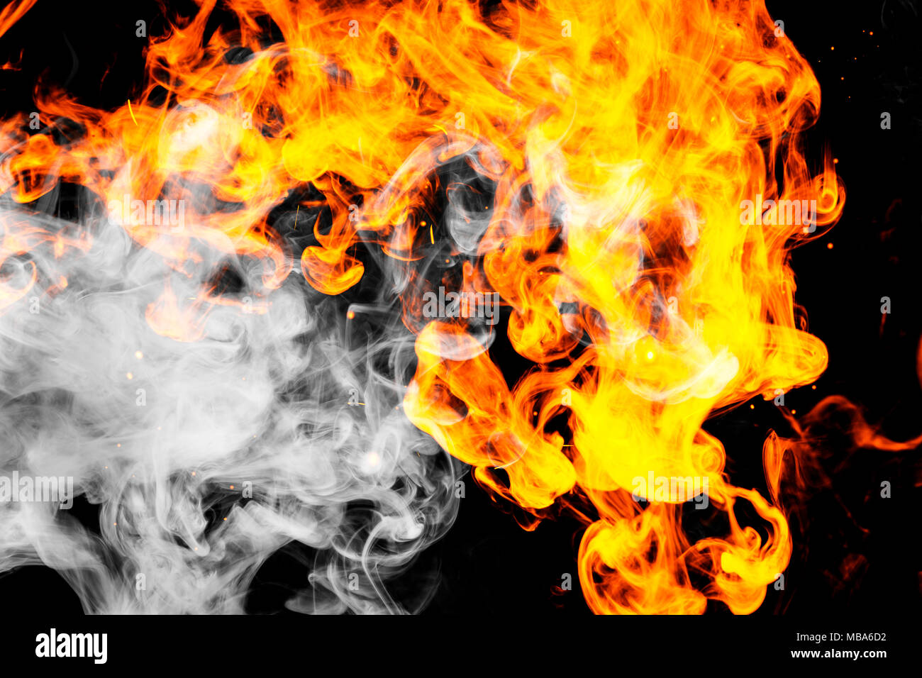 Thick fiary smoke on a black isolated background. Fire flames ...