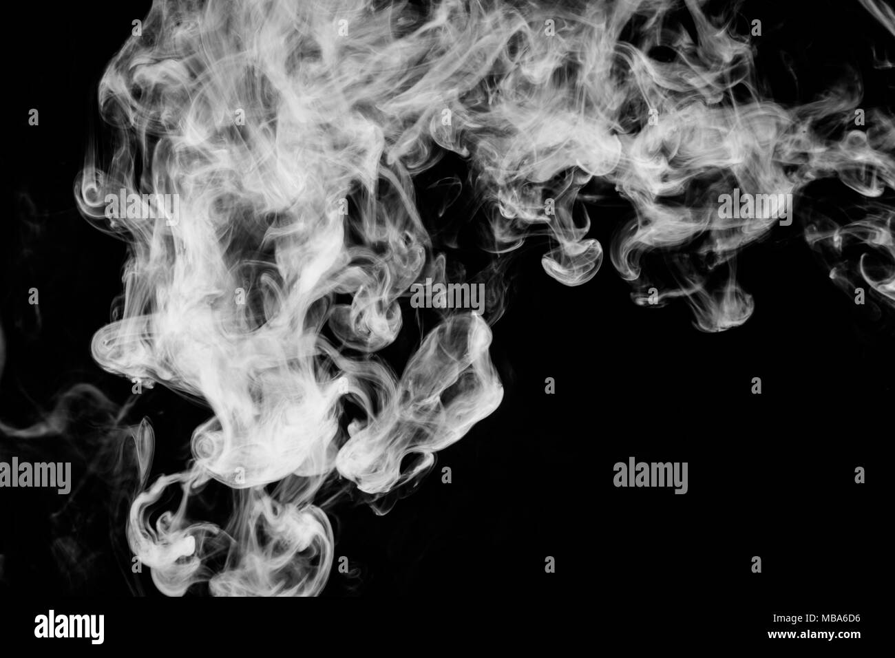 Thick white smoke on a black isolated background. Background from the ...