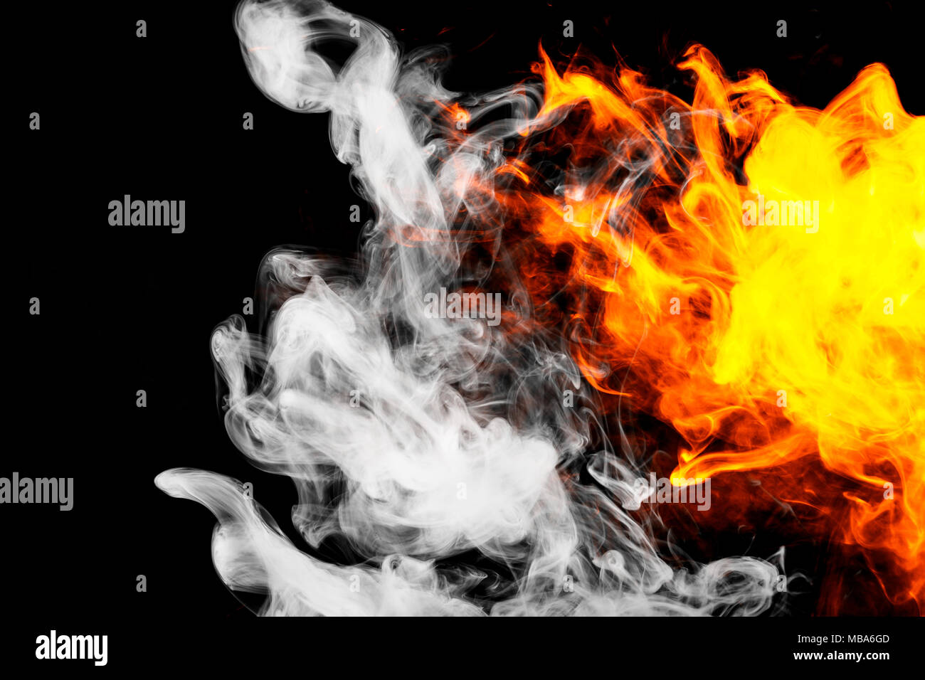 Dense fiery flames smoke on a black isolated background. Background of ...