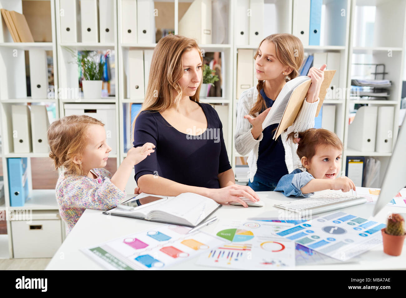 Attracting Attention of Busy Mom Stock Photo - Alamy