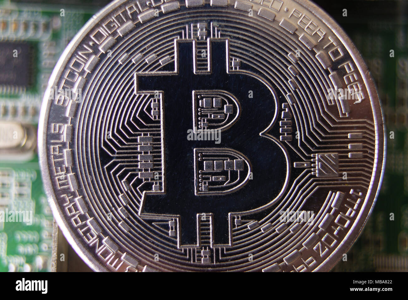 Silver souvenir coin Bitcoin on computer circuit board background Stock ...