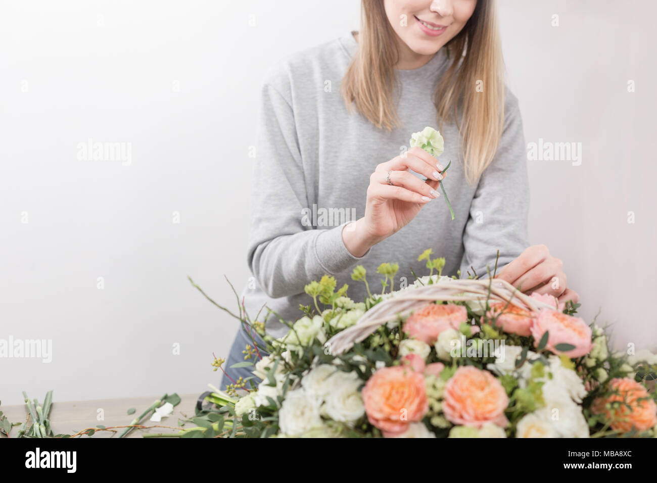 Smiling female florist. Floral workshop - woman making a beautiful ...