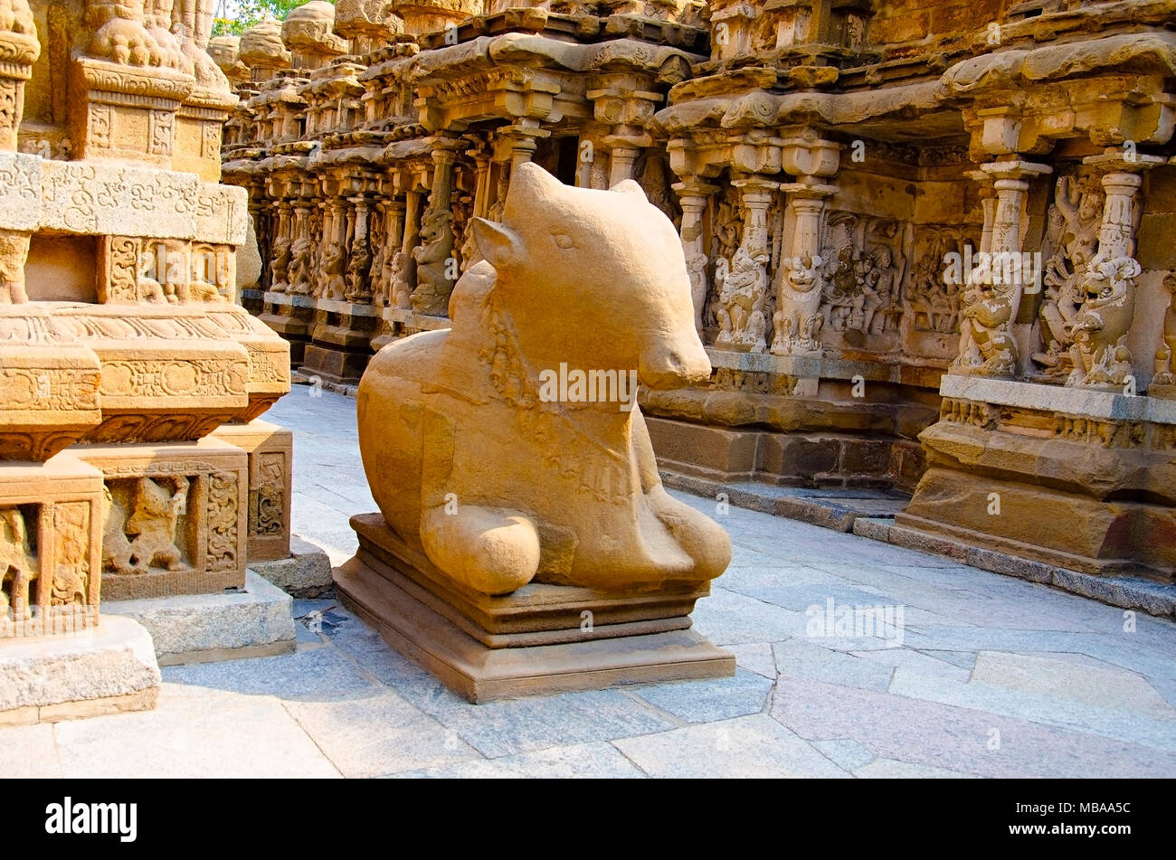 Carved stone Nandi and carved idols on the outer wall of the Kanchi ...