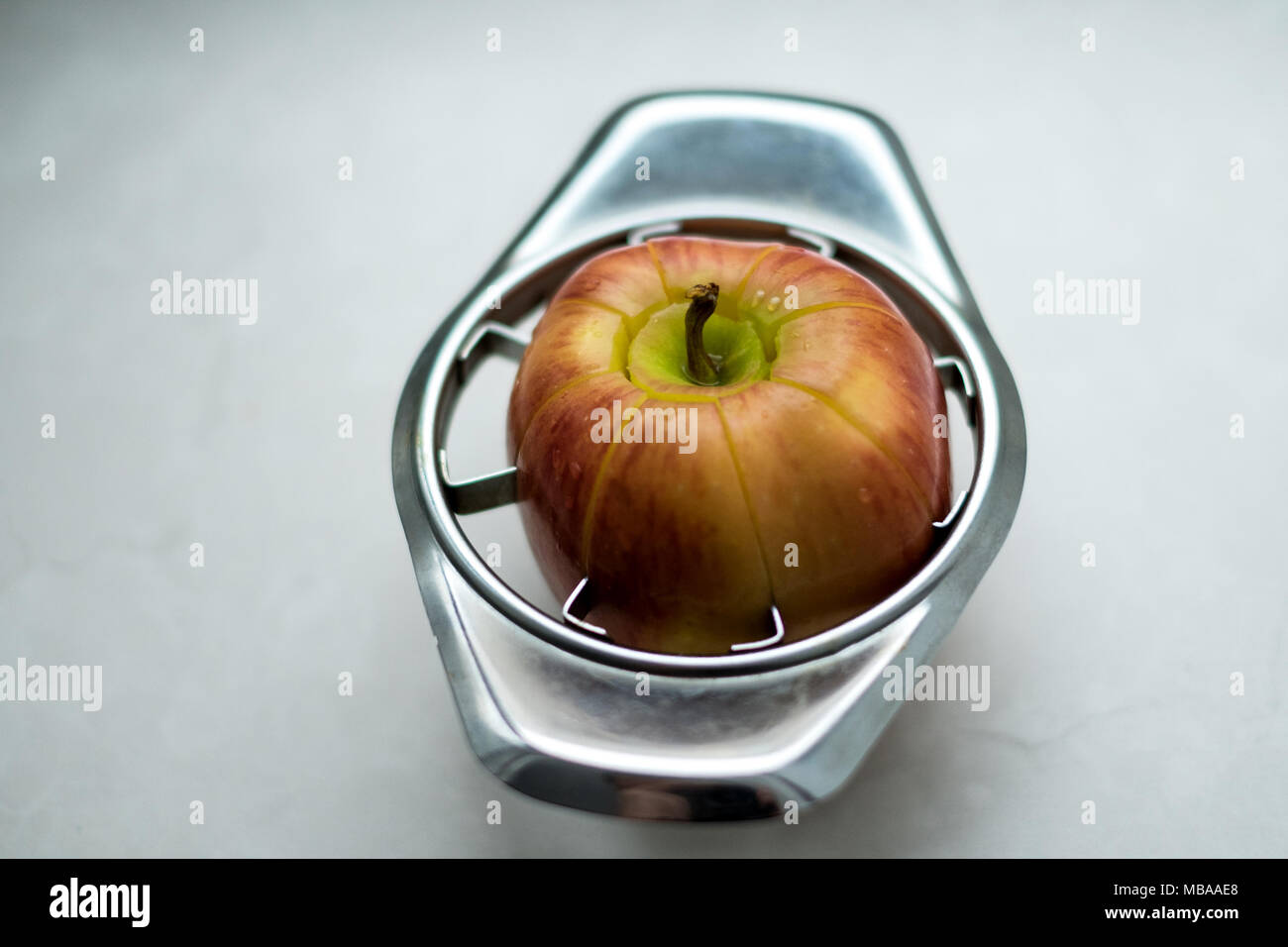Photo of red apple cut into pieces Stock Photo - Alamy