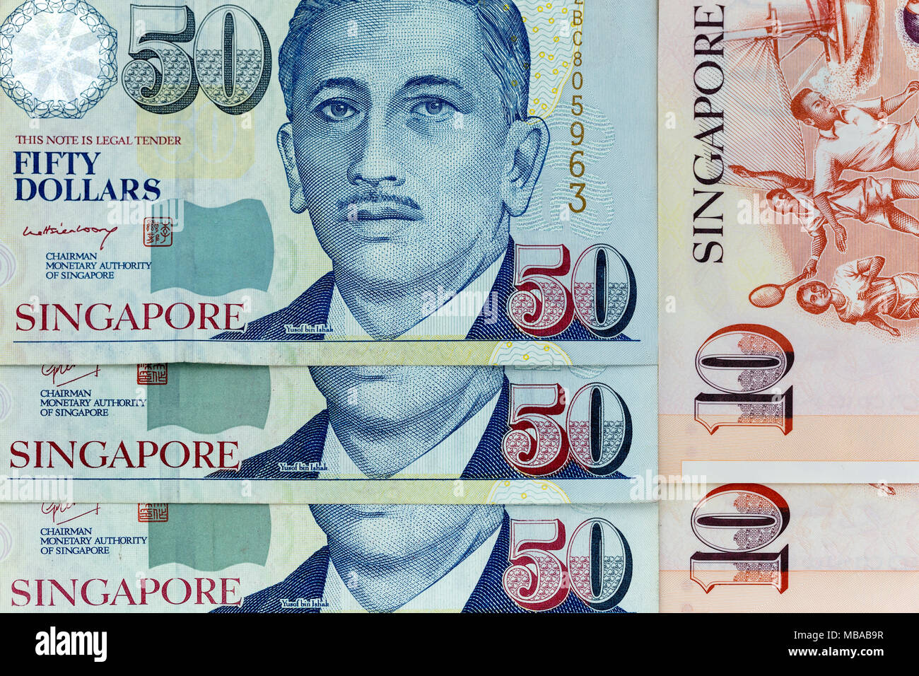 Currency banknotes spread across frame singapore dollar in various ...