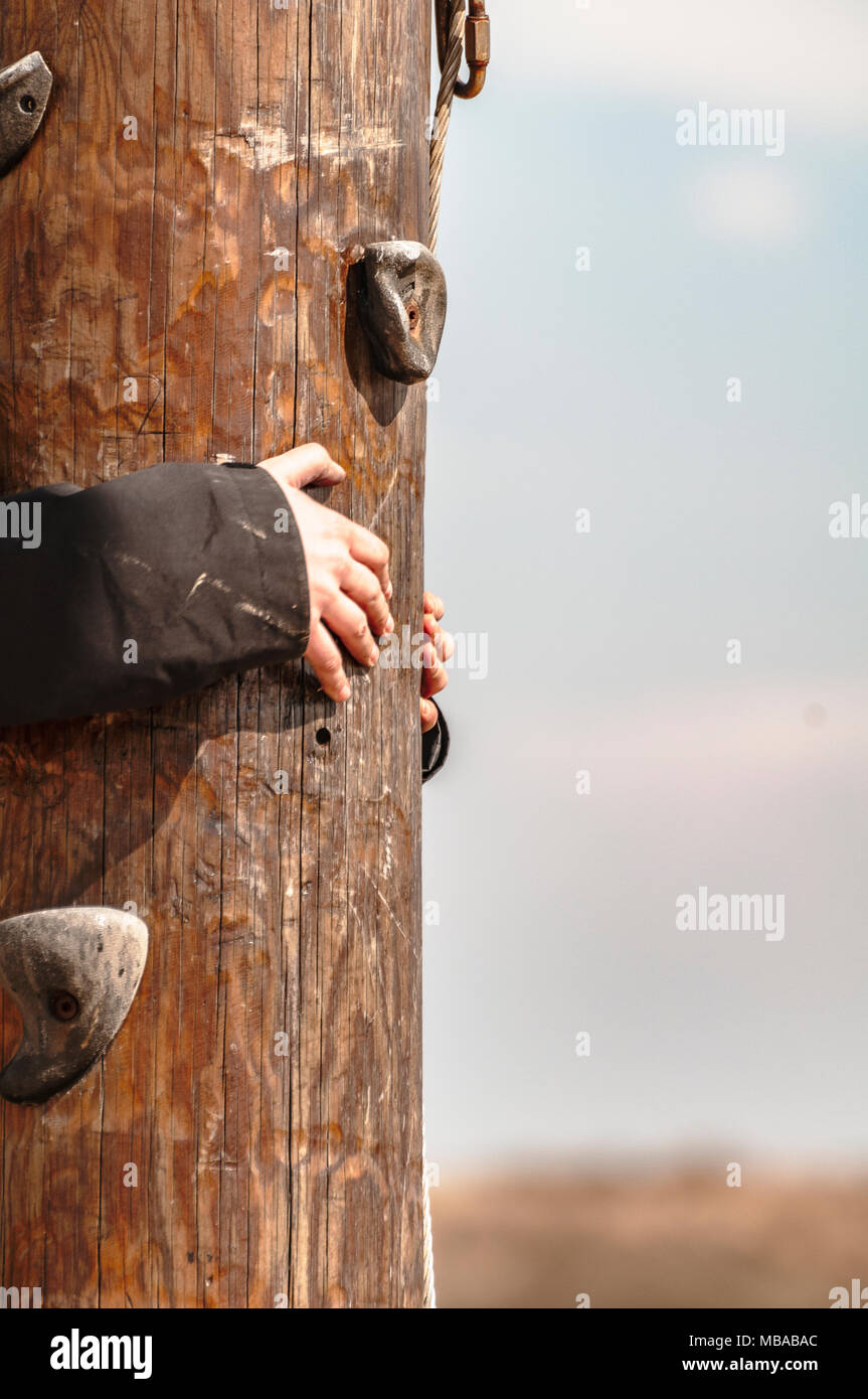 two hands embrace a thick wooden post Stock Photo - Alamy