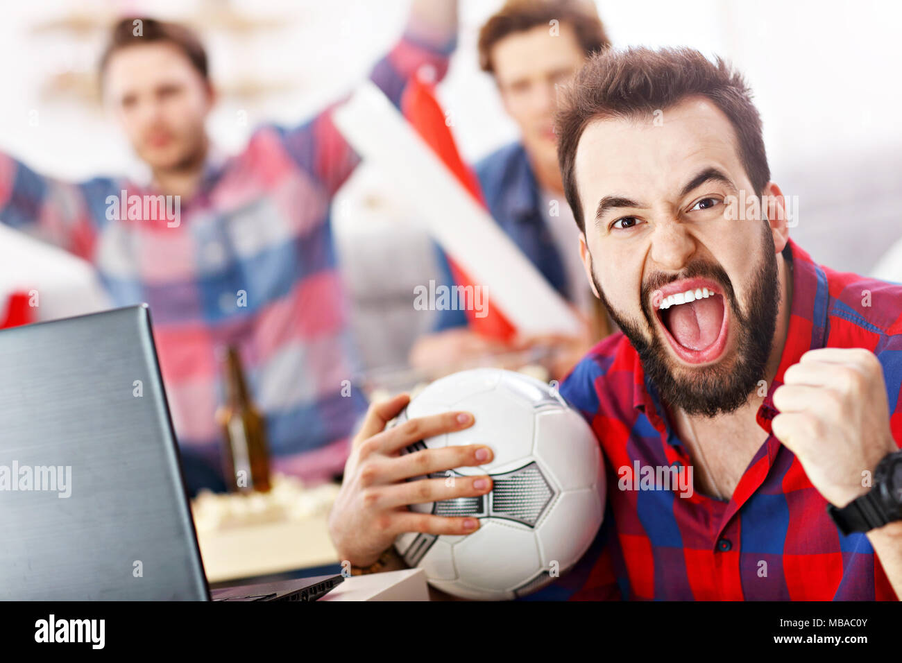 Happy male friends cheering and watching sports on tv Stock Photo - Alamy