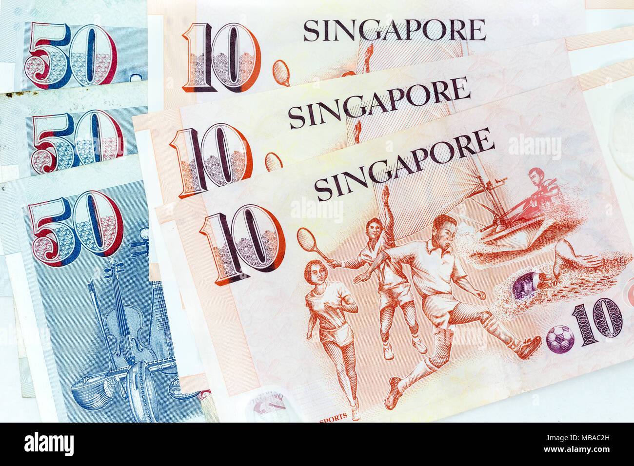 Currency banknotes spread across frame singapore dollar in various ...