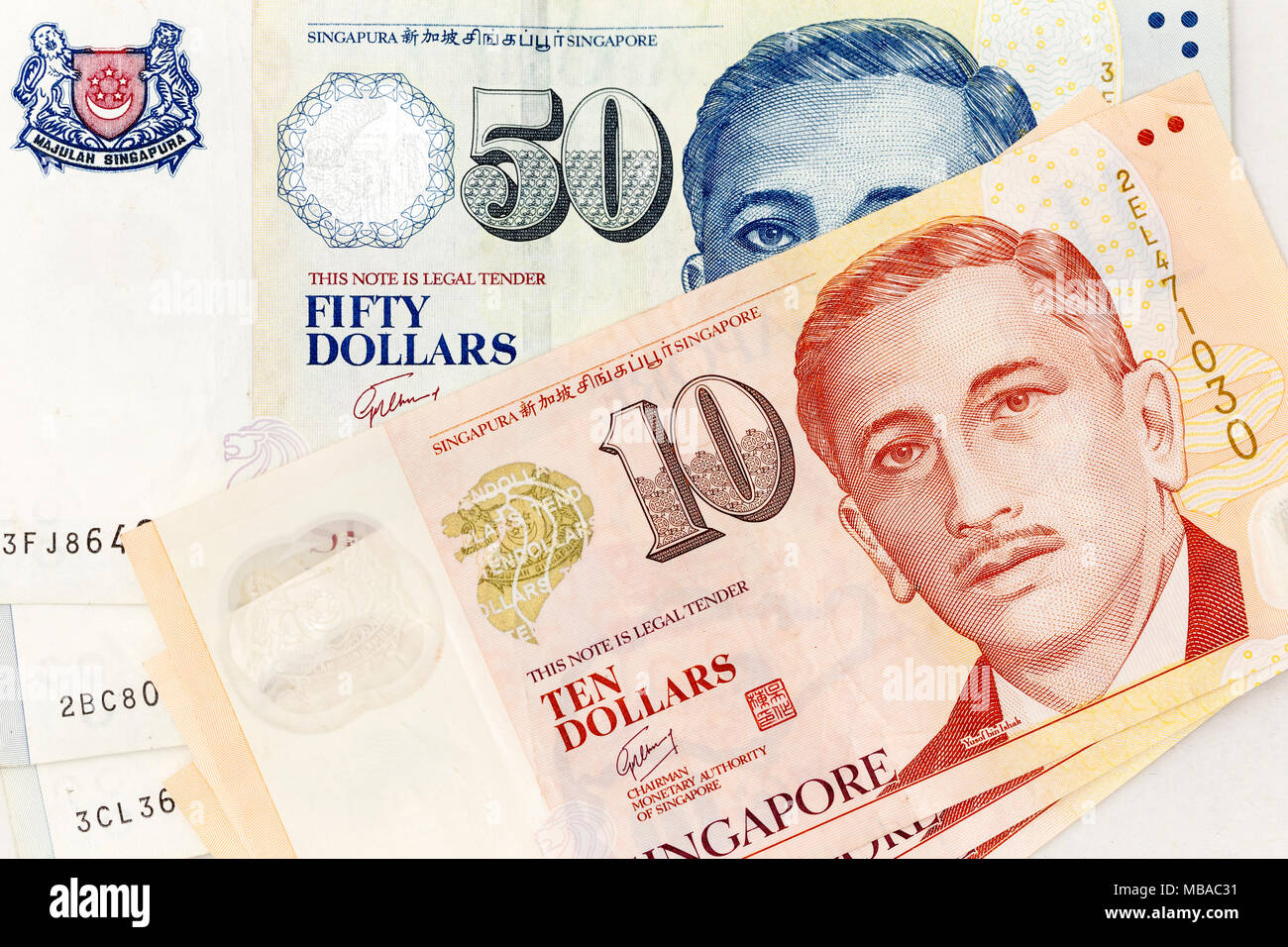 Currency banknotes spread across frame singapore dollar in various ...