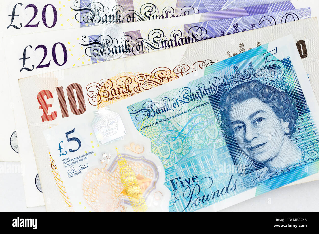 Currency banknotes spread across frame british pound sterling in ...
