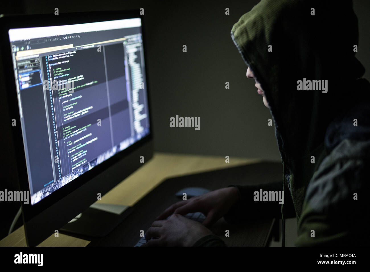 Hacker in hood hi-res stock photography and images - Alamy