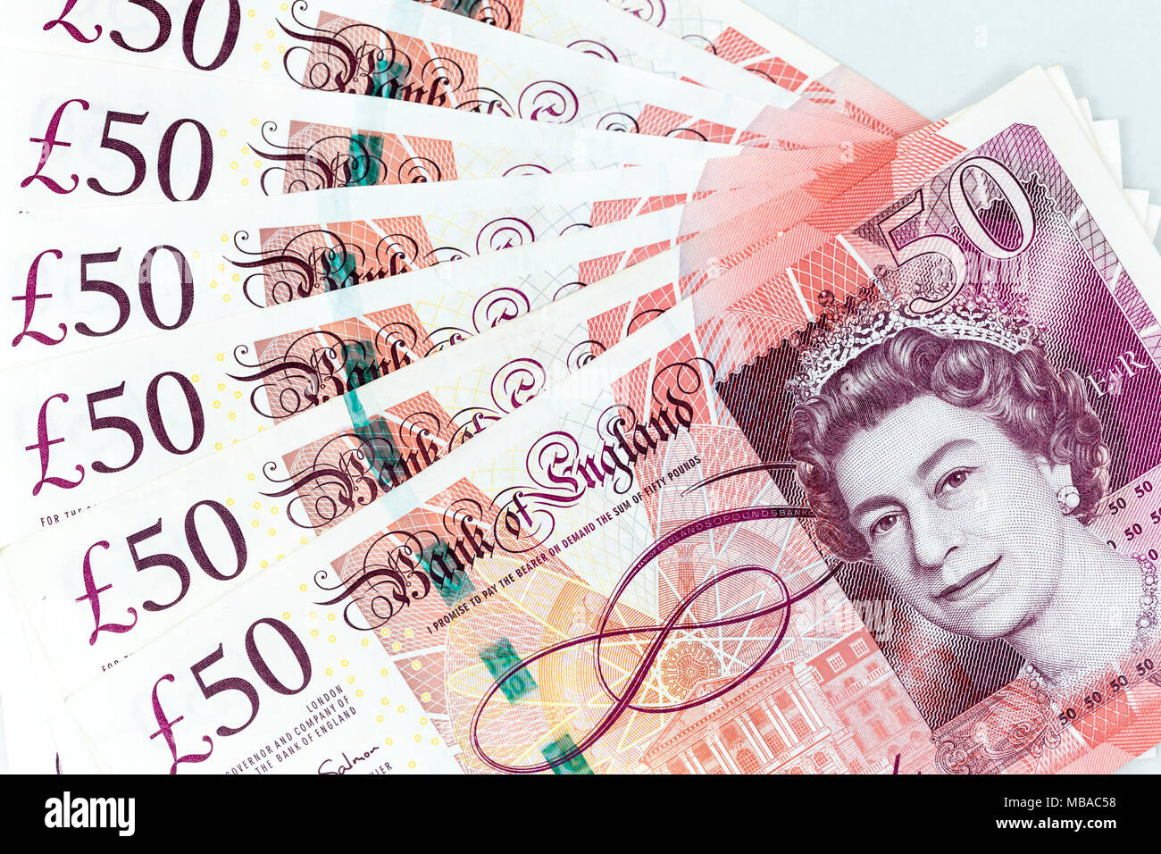 Currency banknotes spread across frame british pound sterling in ...