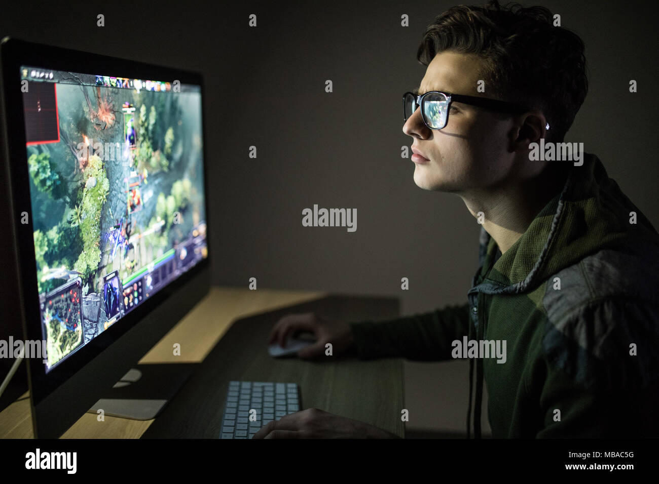 Young hipster man playing online hi-res stock photography and images ...