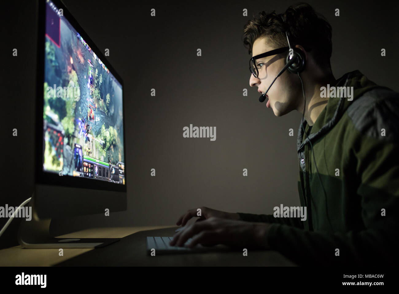 A professional computer player plays on a computer using Stock Photo ...