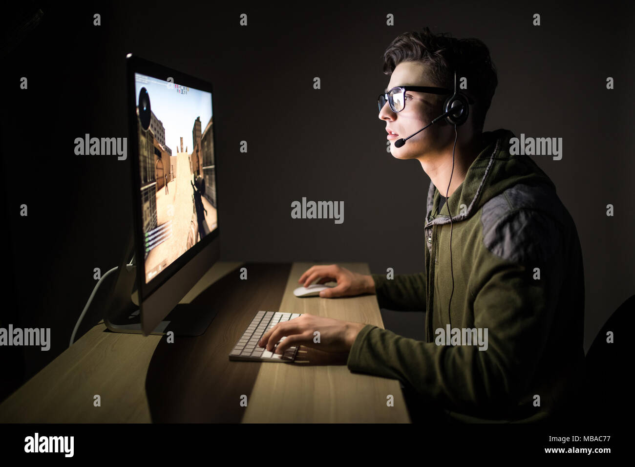 Back view of young gamer playing FPS video games at home Stock Photo ...