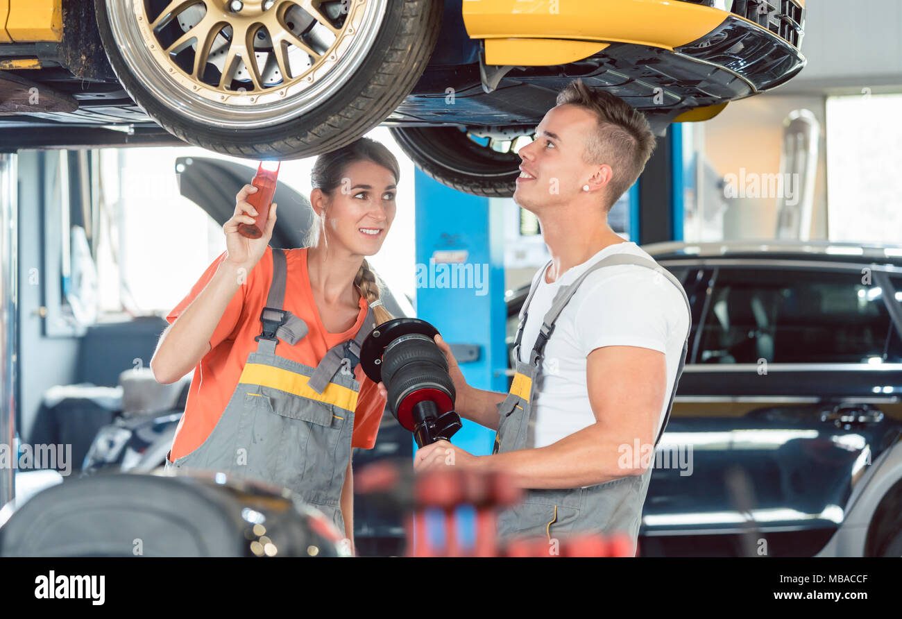 Experienced female auto mechanic with colleague a Stock Photo - Alamy