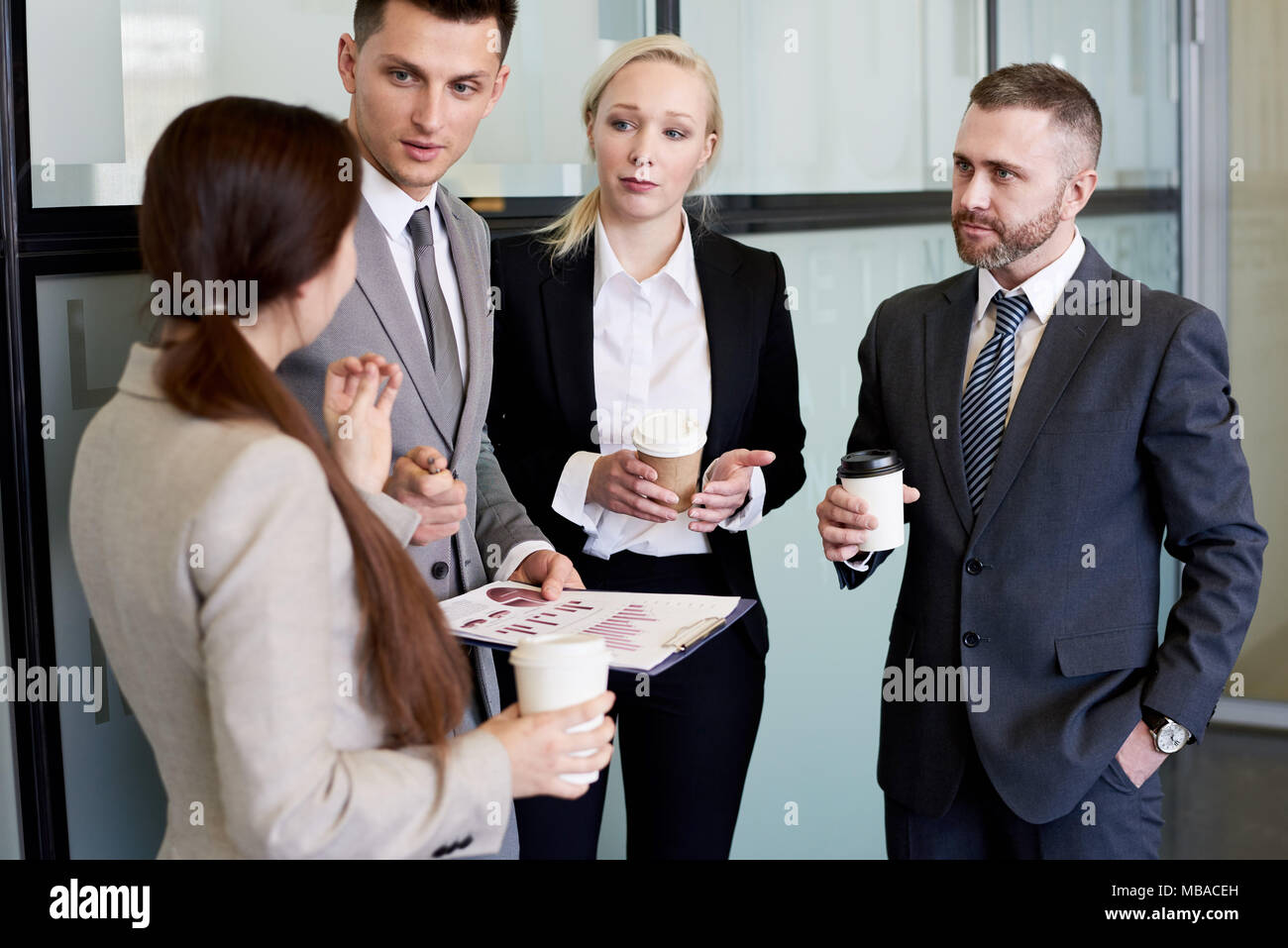 Business Team Chatting at Coffee Break Stock Photo - Alamy