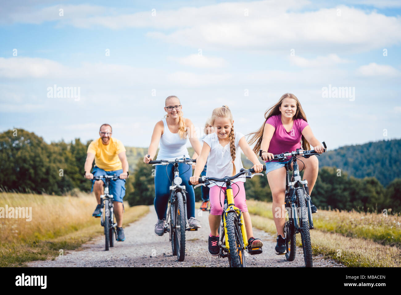 Family with children riding bicycles hi-res stock photography and ...