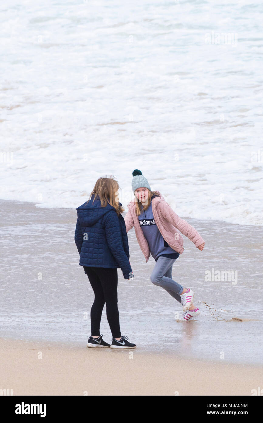 Young teenage girls playing on Fistral Beach in Newquay Cornwall Stock ...