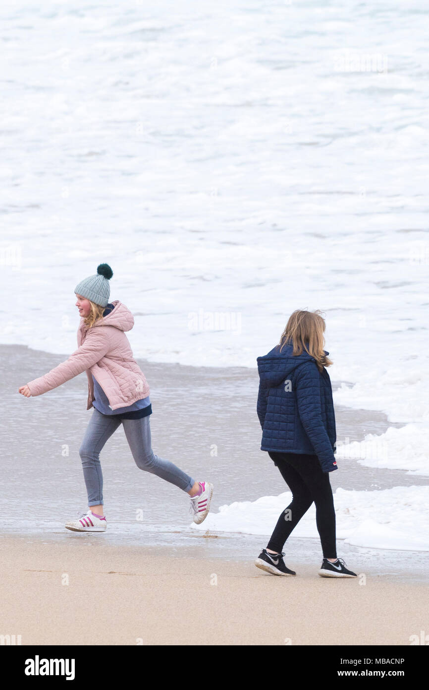 Young teenage girls playing on Fistral Beach in Newqauy Cornwall Stock ...