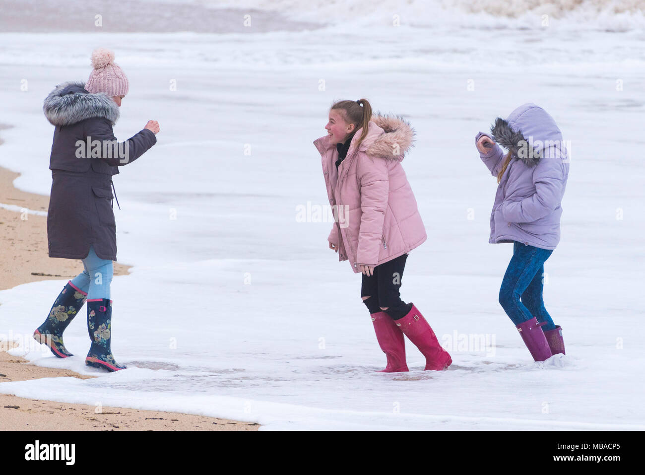 Young teenage girls playing on Fistral Beach in Newquay Cornwall Stock ...