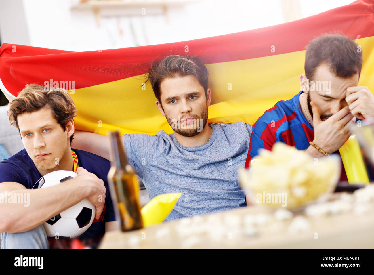 Happy male friends cheering and watching sports on tv Stock Photo - Alamy