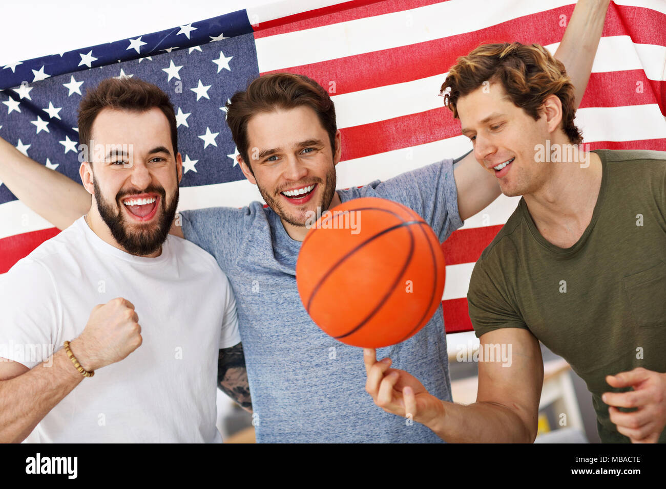 Happy american basketball fans cheering over flag Stock Photo - Alamy