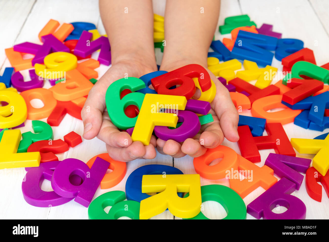 Child learning using magnetic letters. Education School Concept Stock ...