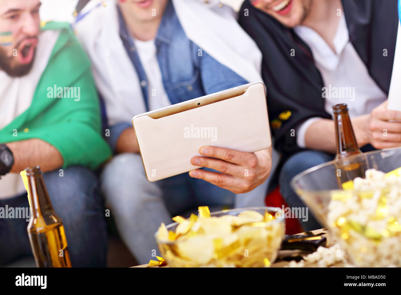 Happy male friends cheering and watching sports on tv Stock Photo - Alamy