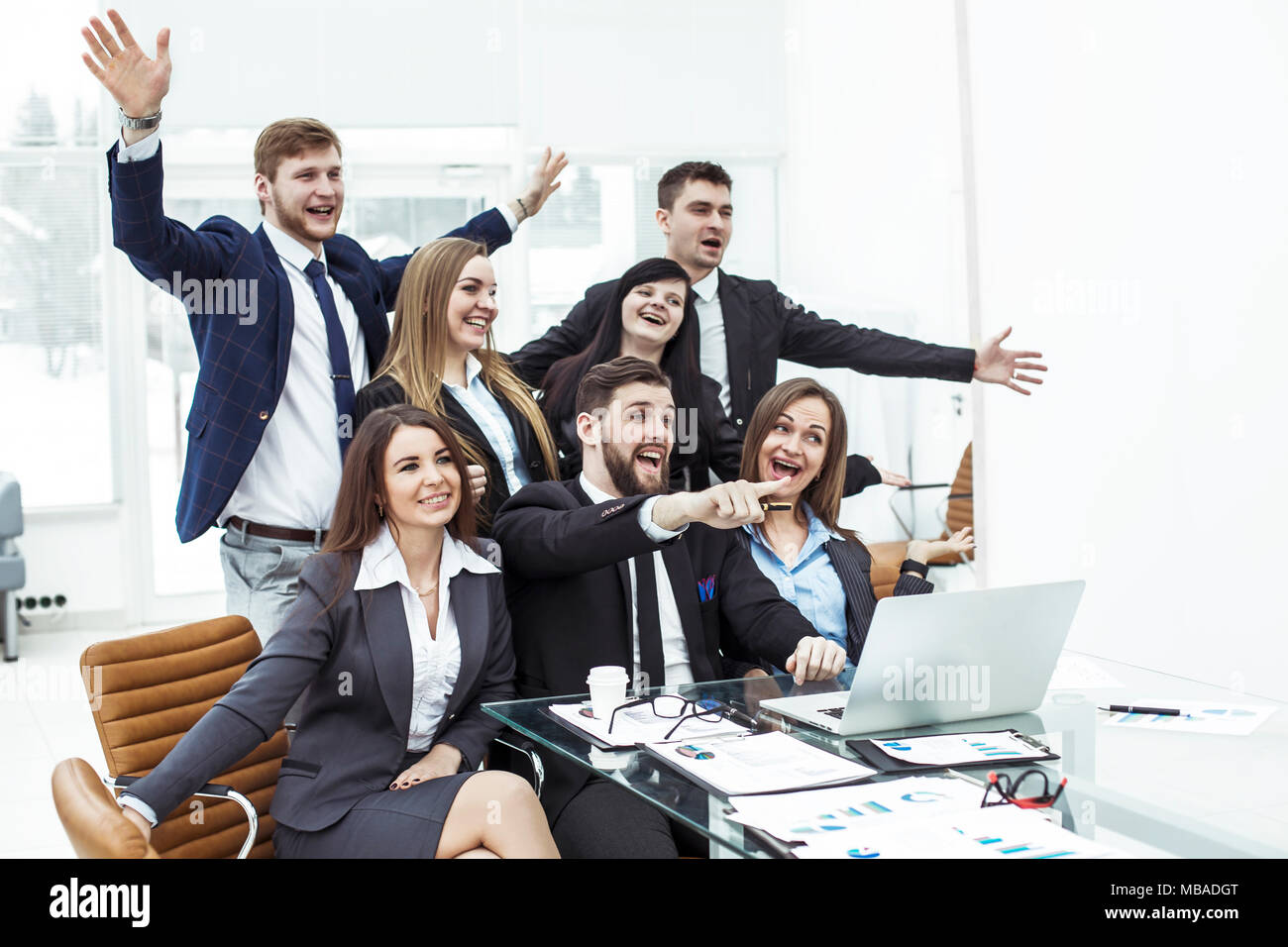 concept of business success - cheering business team in the workplace ...