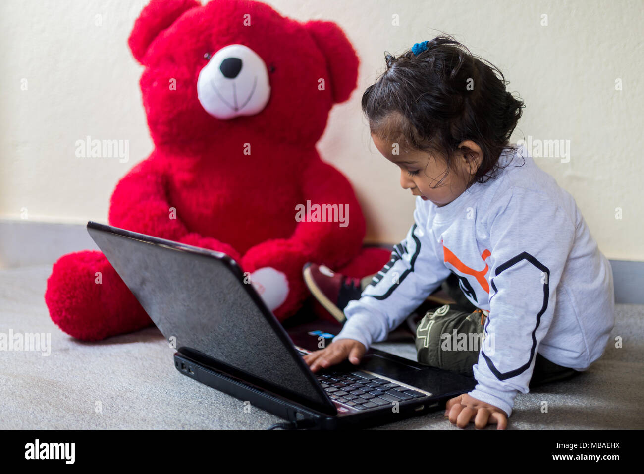 Baby Child Playing,laying on the Floor and Using a Laptop Computer ...