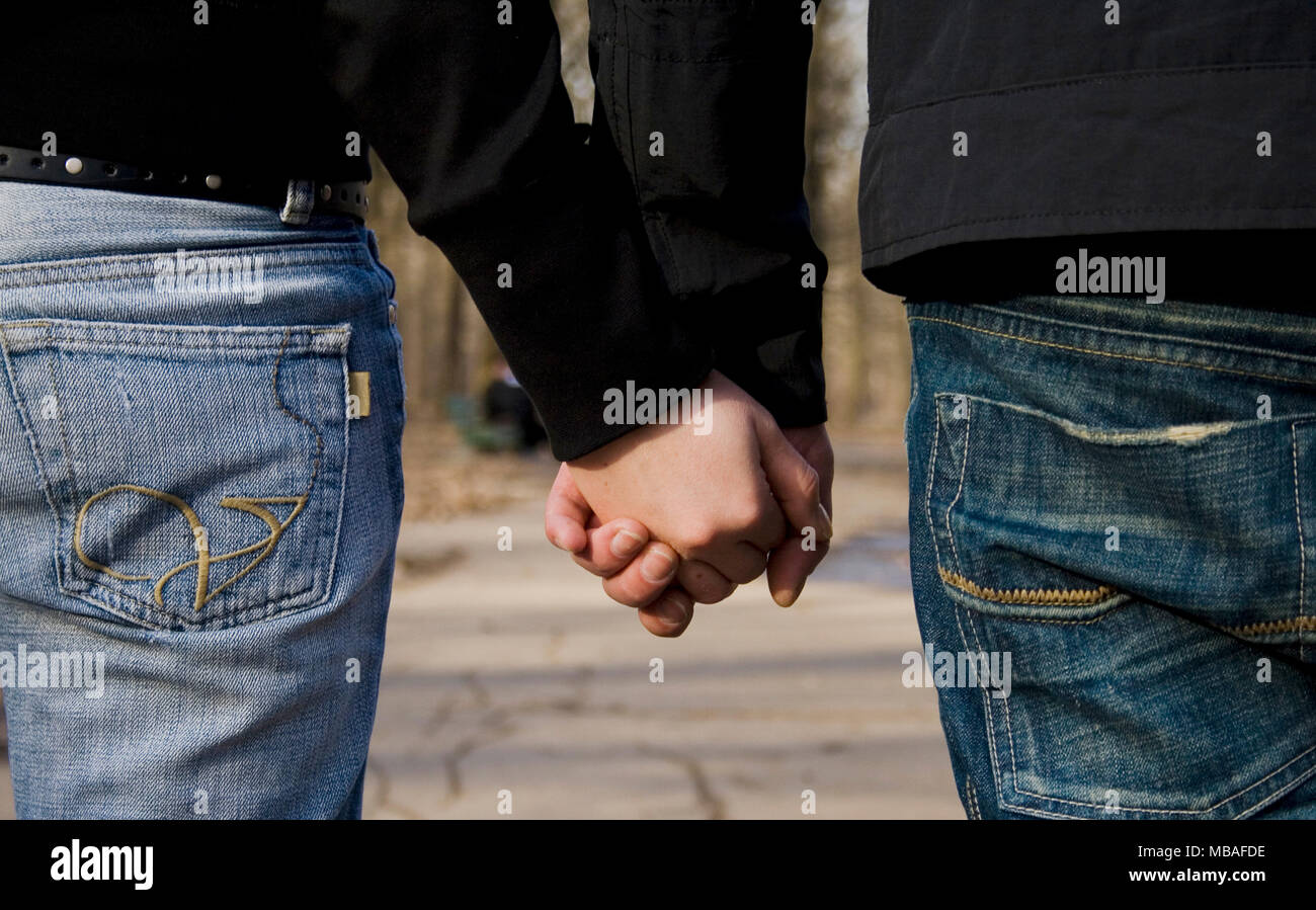 young people walking in the park hand in hand Stock Photo - Alamy